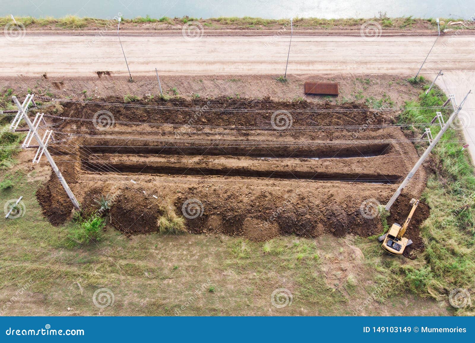 Yellow Backhoe Digging Furrow on Soil in the Agricultural Area Stock ...