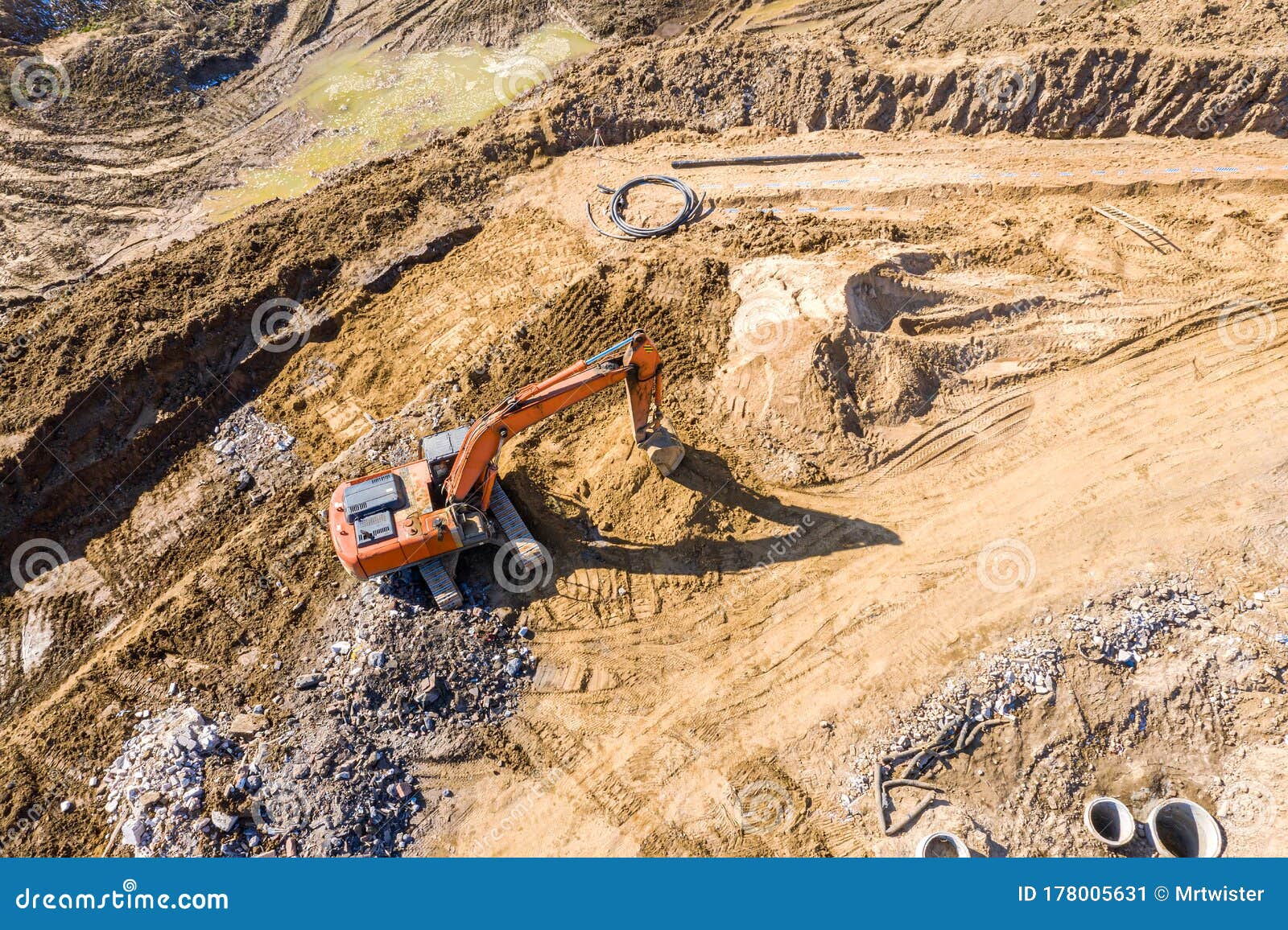 Yellow Backhoe Moving Ground on Construction Site. Aerial View Stock ...
