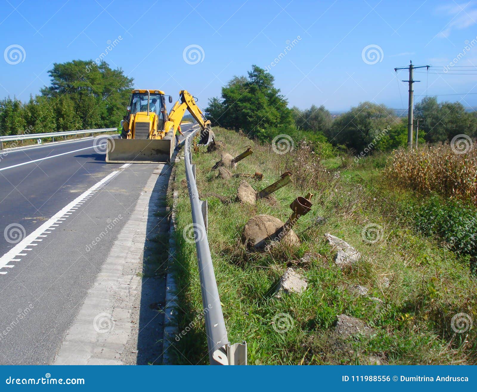 Yellow backhoe on road stock photo. Image of excavate - 111988556