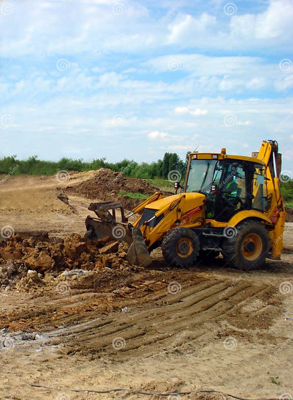 Yellow backhoe working stock photo. Image of gravel - 113469198