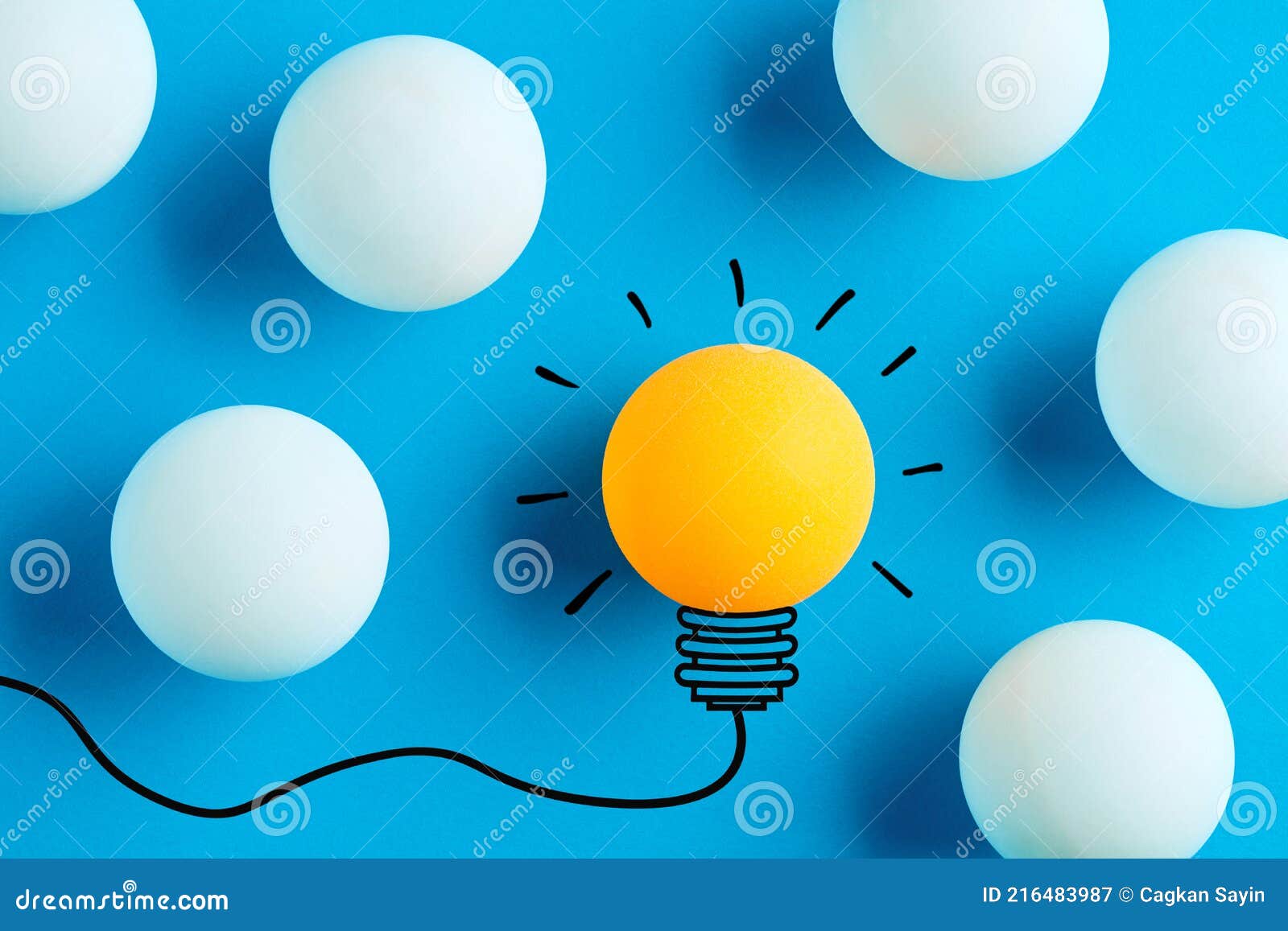 Yellow Ball Designed As a Light Bulb among Dimmed Balls on Blue ...