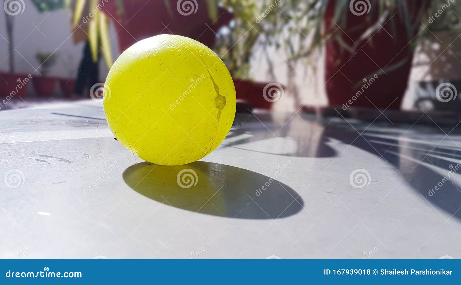 A Yellow Ball with Its Shadow Falling on the Ground Stock Photo - Image ...