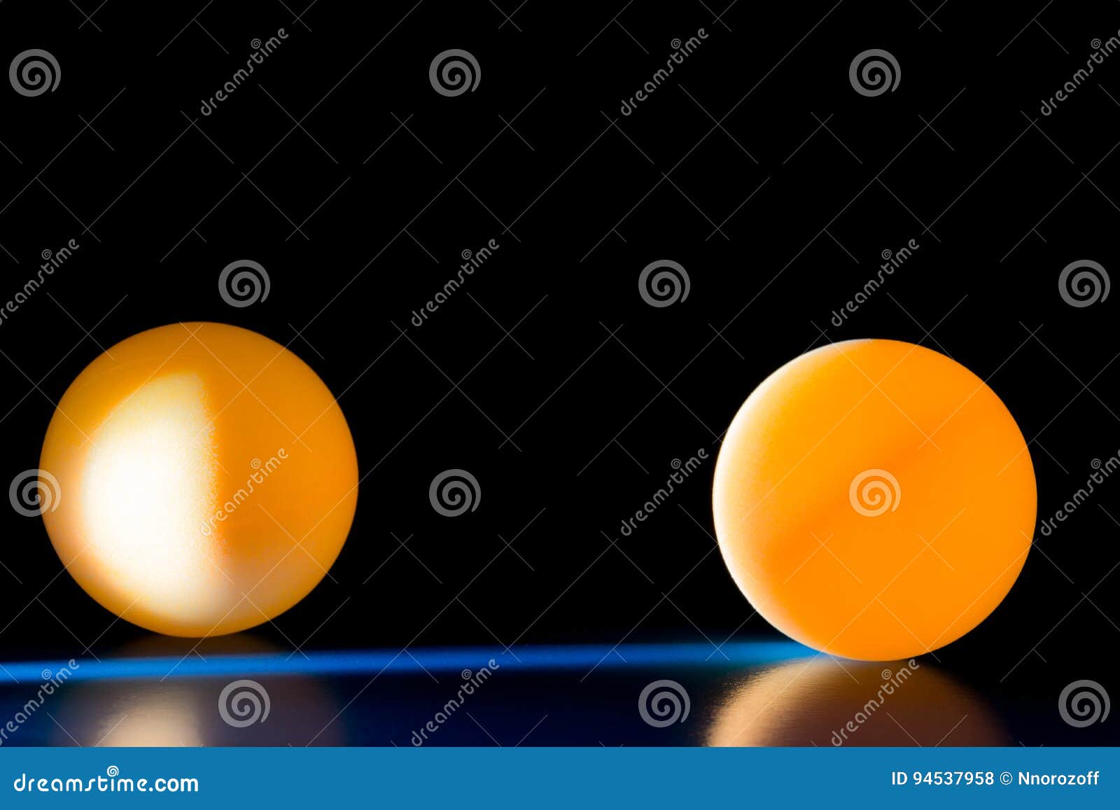 Yellow Balls on a Blue Dark Background Illuminated by a Side Beam of ...