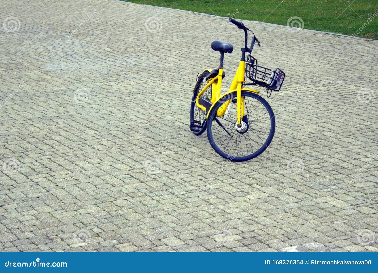 A Yellow Bicycle Stands on a Cobblestone Pavement Stock Photo - Image ...