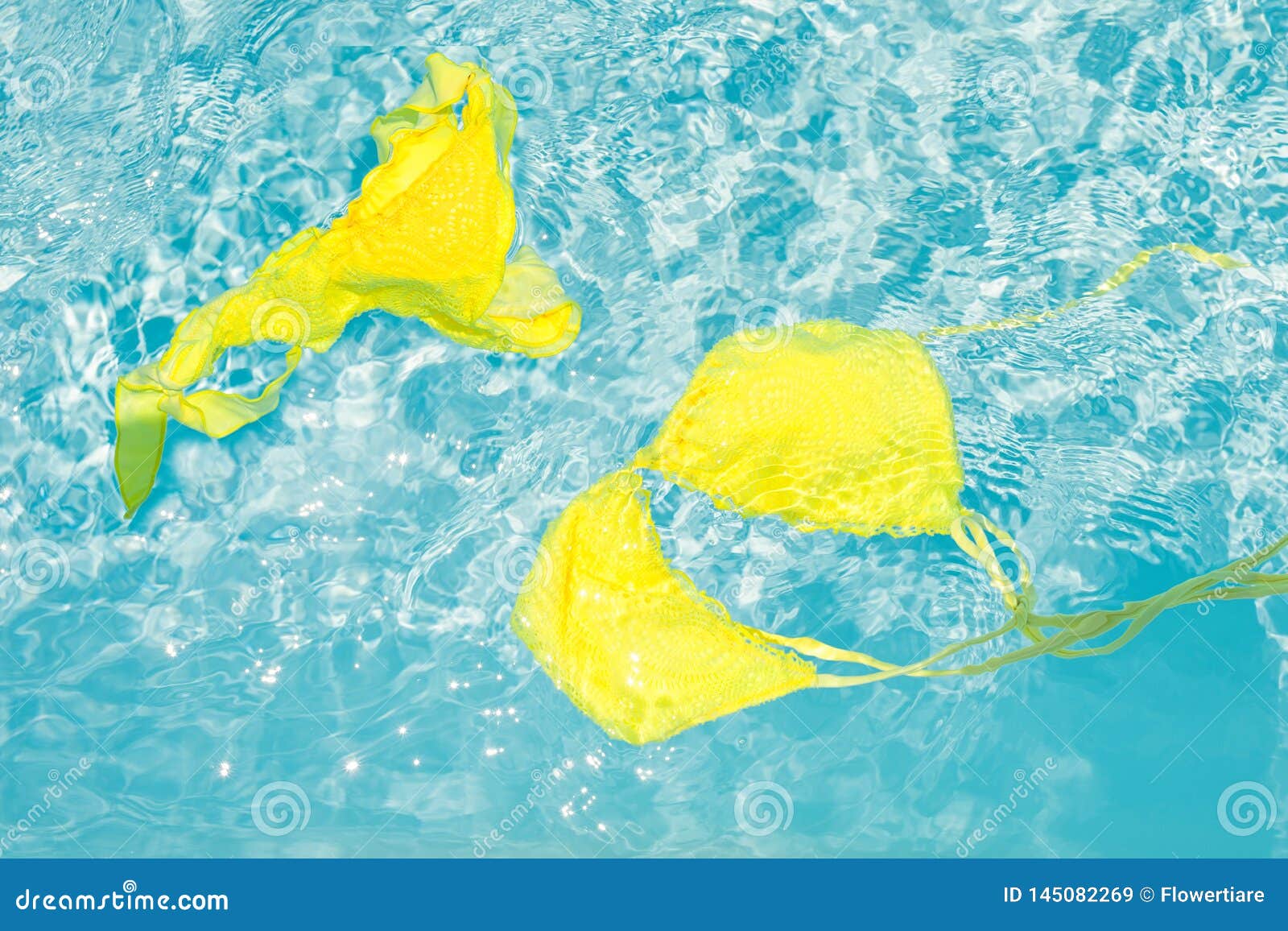 Yellow Bikini in Clean Blue Water of the Pool. Vertical Size. Stock ...
