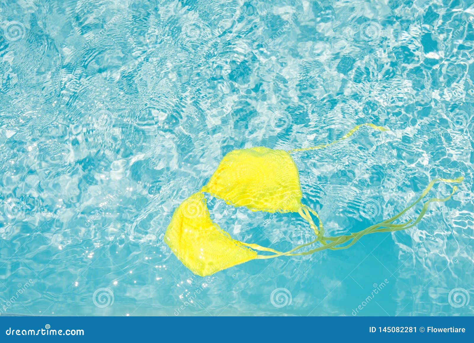 Yellow Bikini in Clean Blue Water of the Pool. Vertical Size. Stock ...