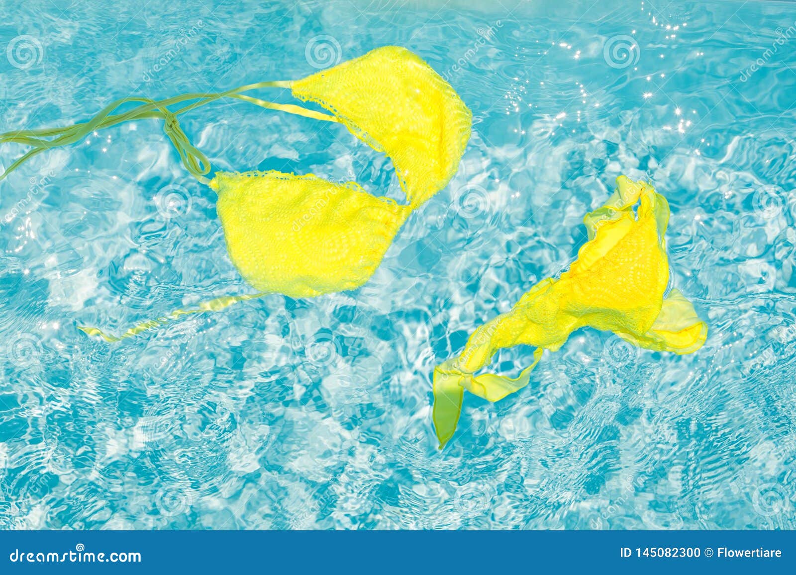 Yellow Bikini in Clean Blue Water of the Pool. Vertical Size. Stock ...