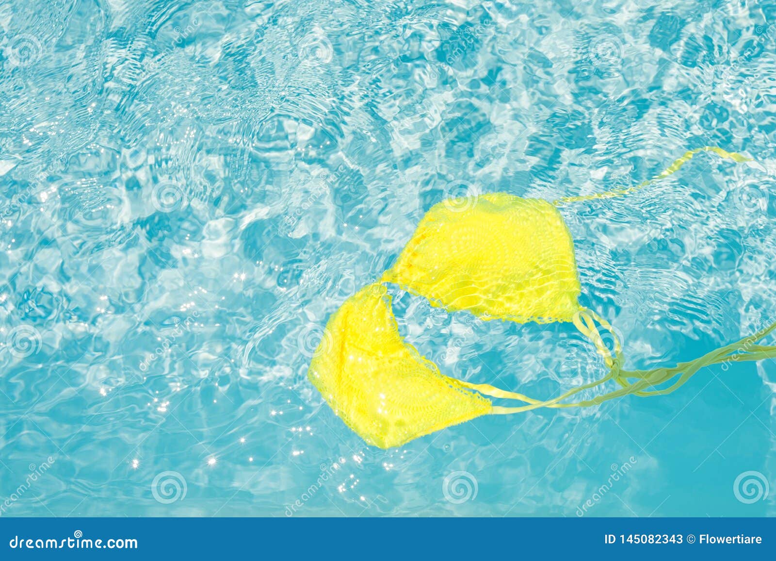 Yellow Bikini in Clean Blue Water of the Pool. Vertical Size. Stock ...