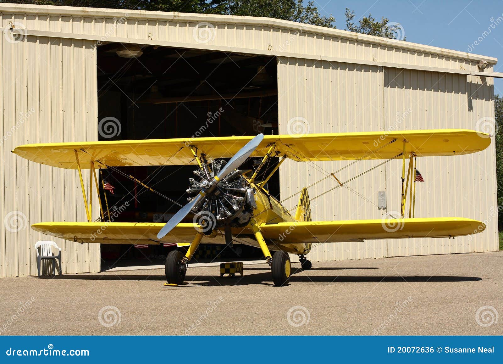 Yellow Biplane in Front of Hangar Stock Photo - Image of cockpit, wings ...