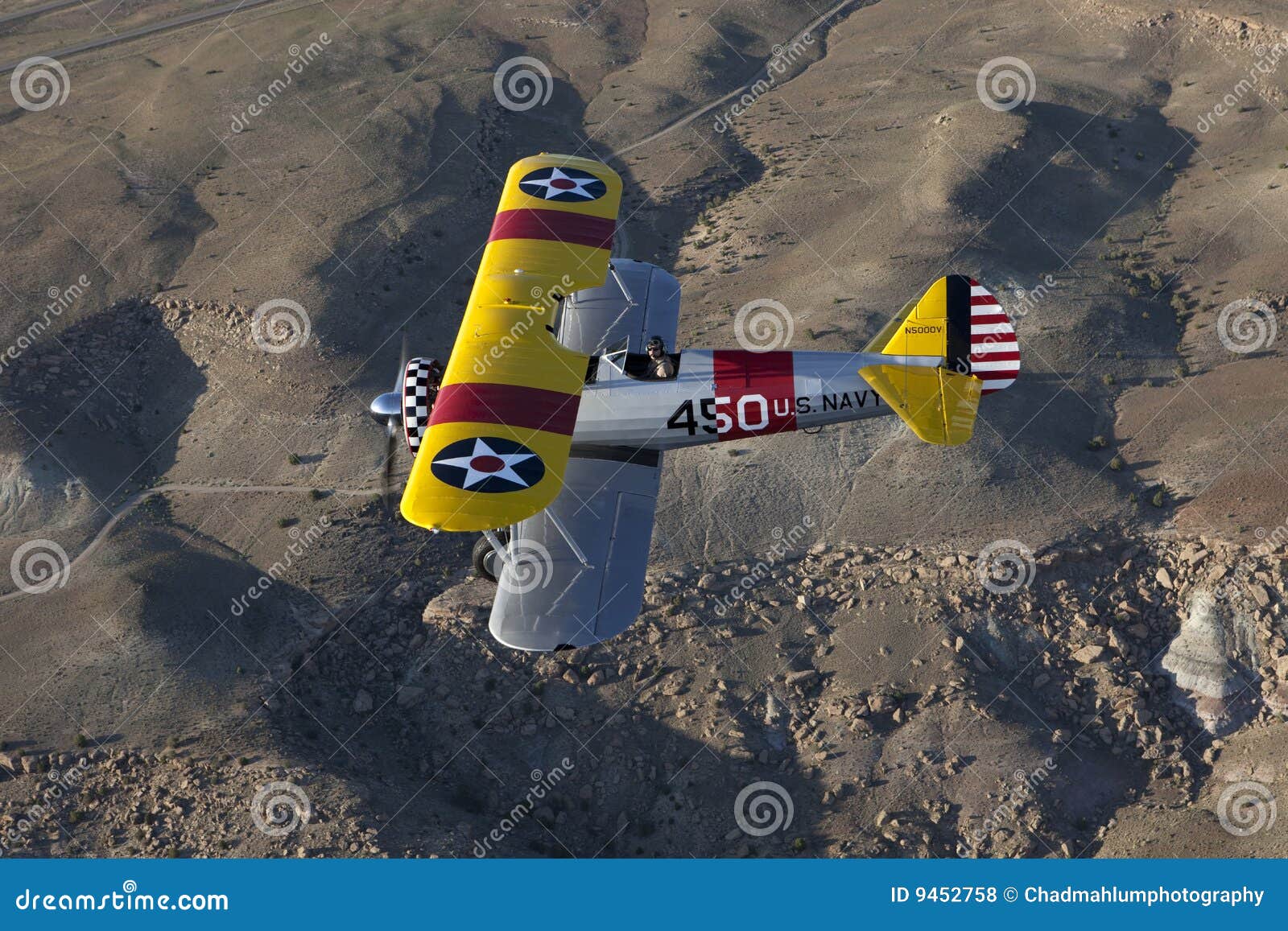 Yellow biplane over desert stock photo. Image of flying - 9452758