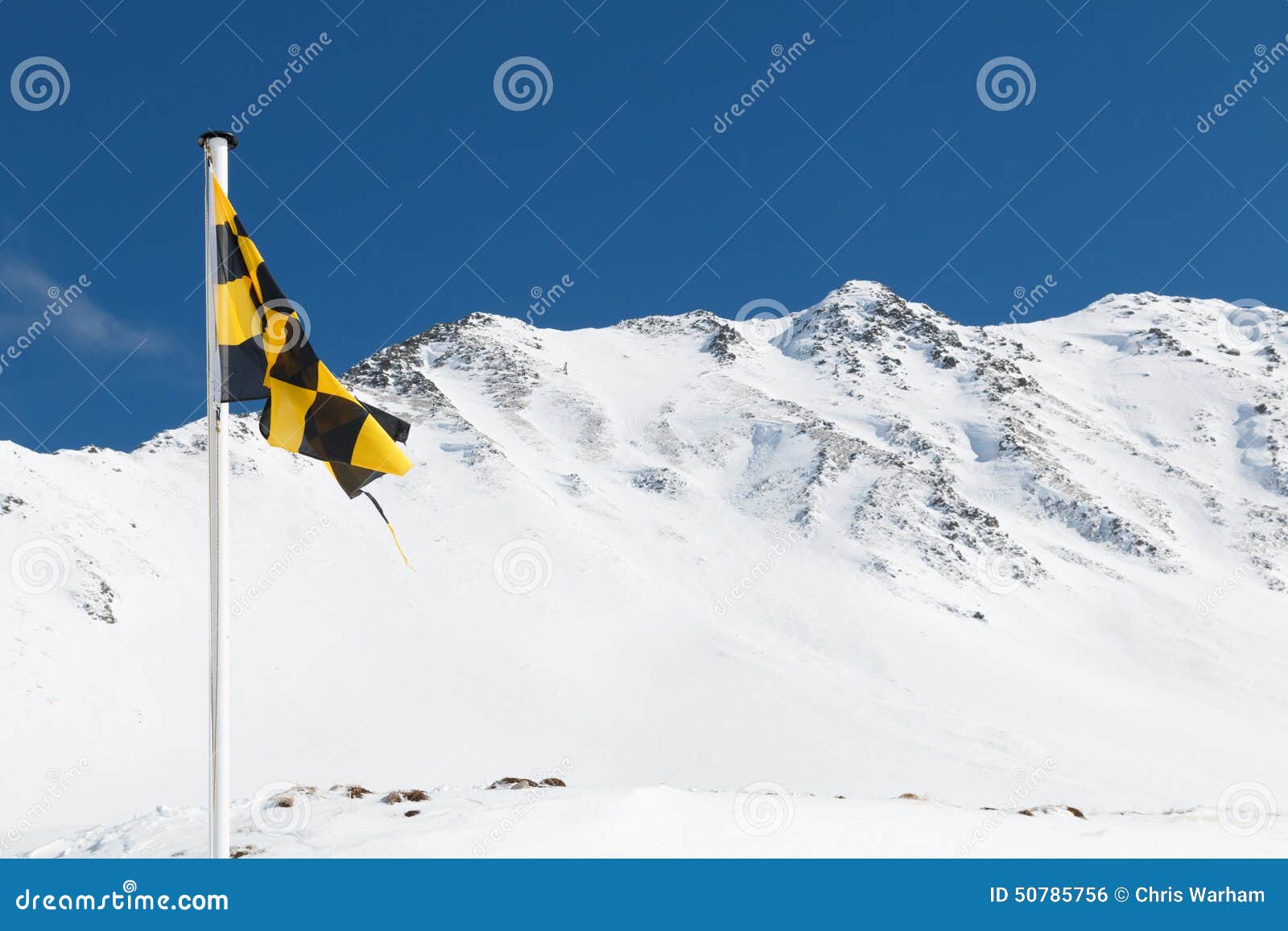Yellow and Black Avalanche Risk Warning Flag Flying in the Mount Stock ...