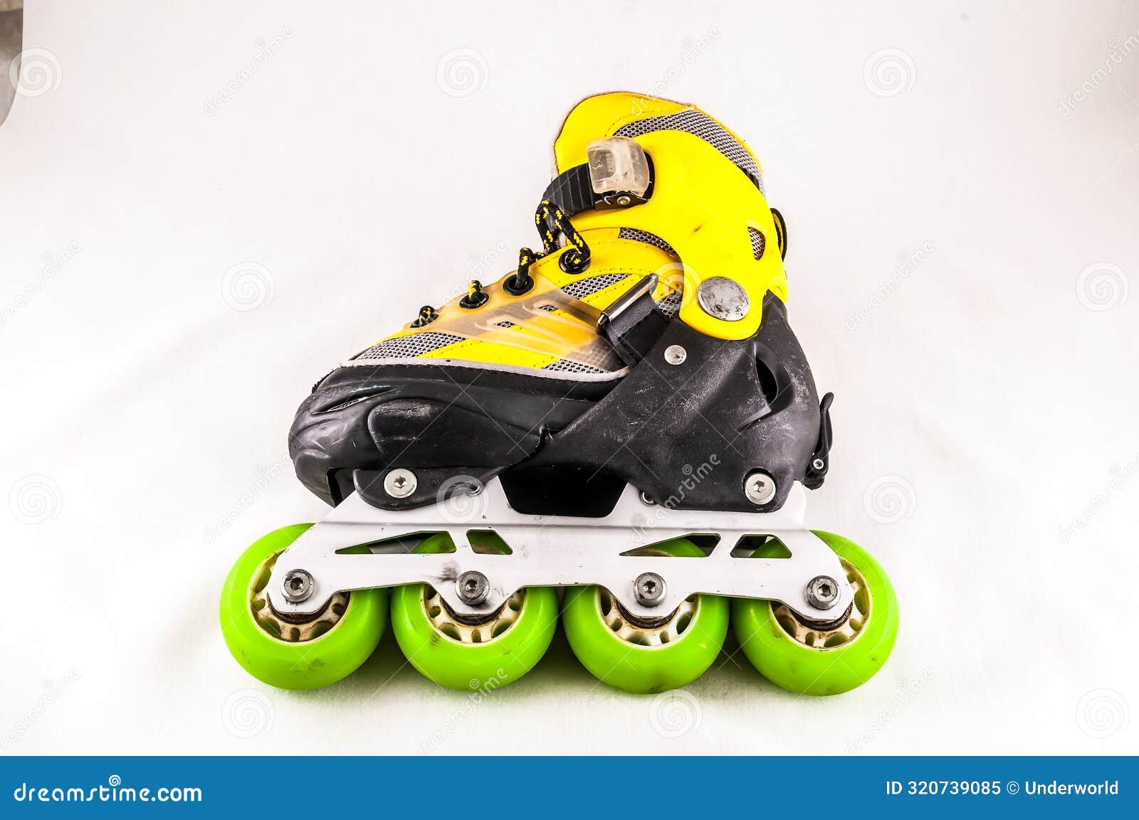 A Yellow and Black Roller Skate with Green Wheels Stock Image - Image ...