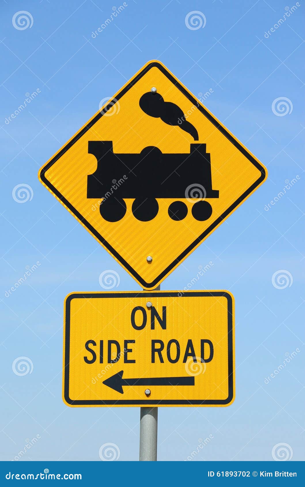 Yellow and Black Trains on Side Road Sign in a Cloudless Blue Sky Stock ...