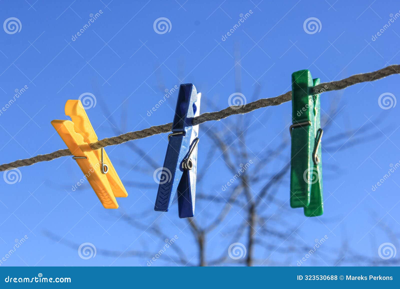 A Yellow and a Blue and Green Clothes Peg are Clipped at Different ...
