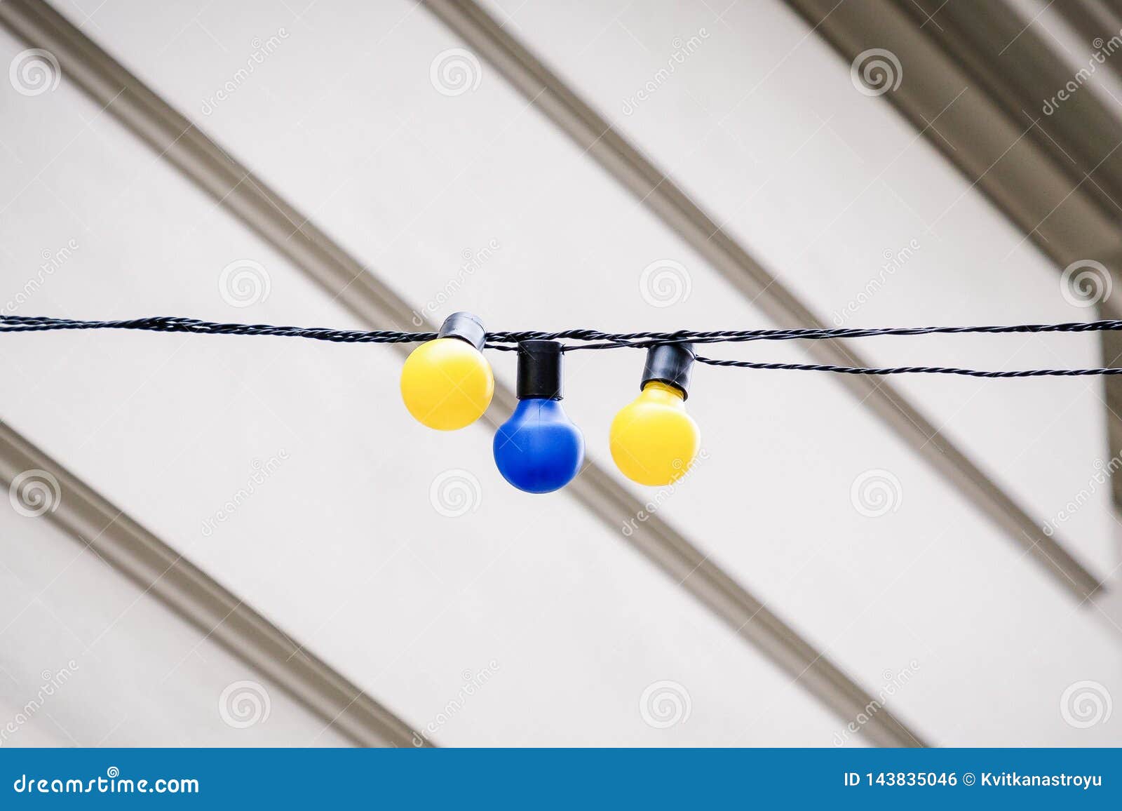 Yellow and Blue Light Bulbs on the Wall Background Stock Photo - Image ...