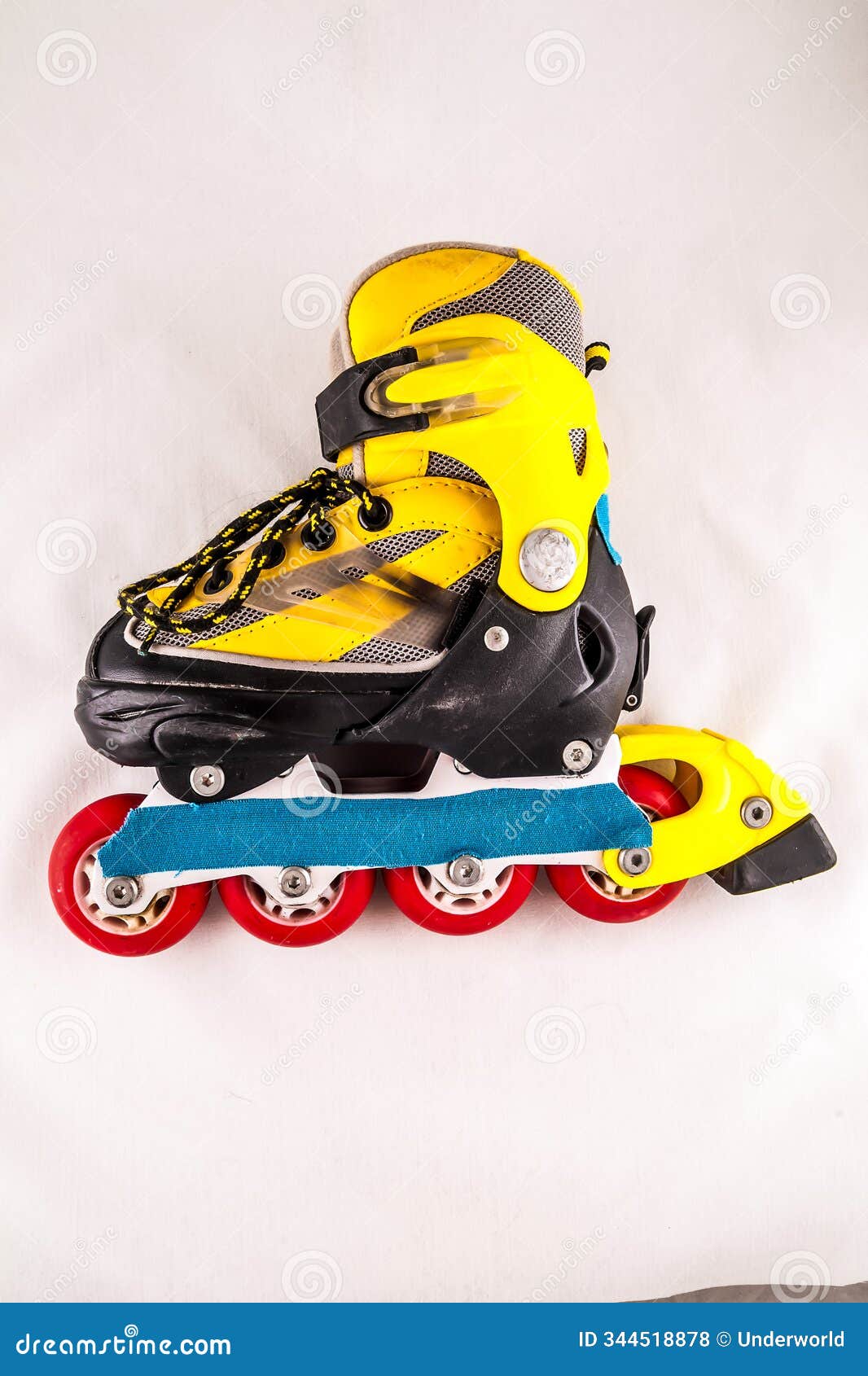 A Yellow and Blue Roller Skate with Red Wheels Stock Photo - Image of ...