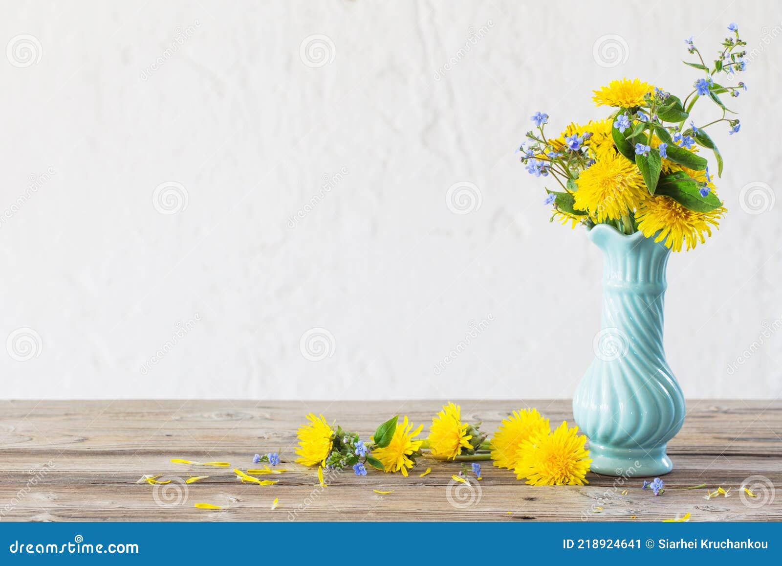 The Yellow and Blue Spring Flowers S in Blue Vase on White Background ...