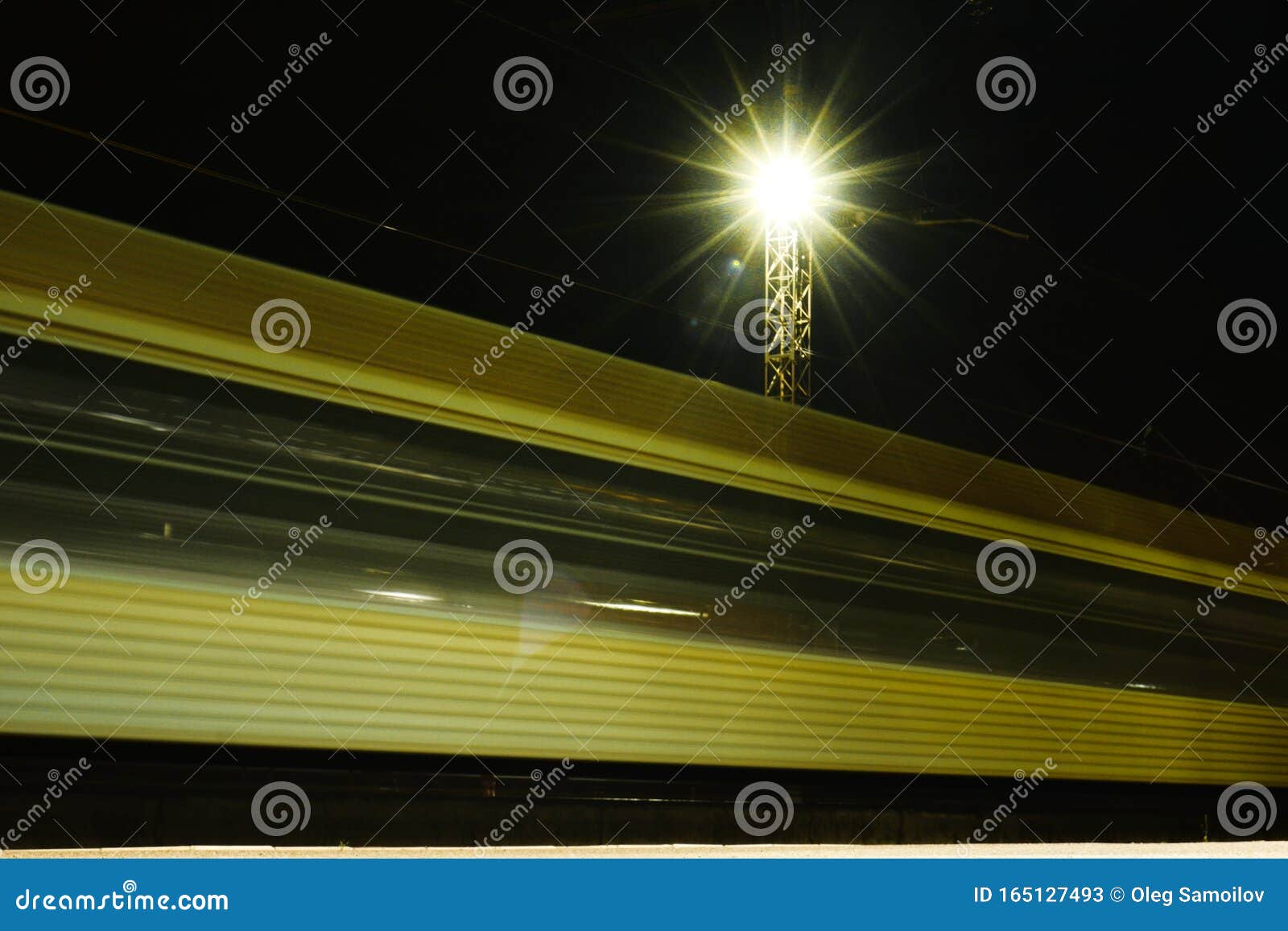 Yellow and Blue Train with Lights Passing by in the Night. Stock Image ...