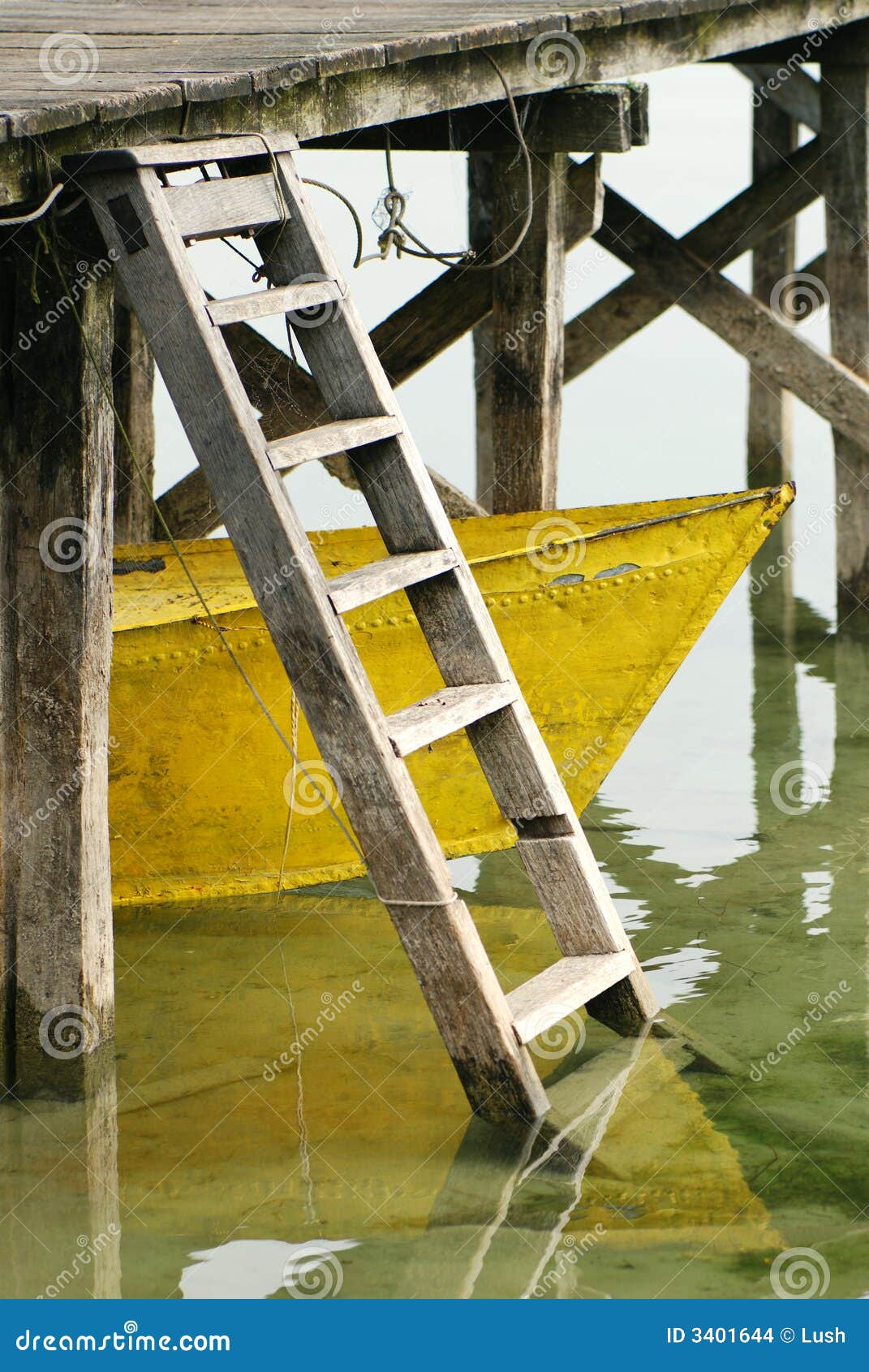 Yellow boat under the dock stock photo. Image of boardwalk - 3401644