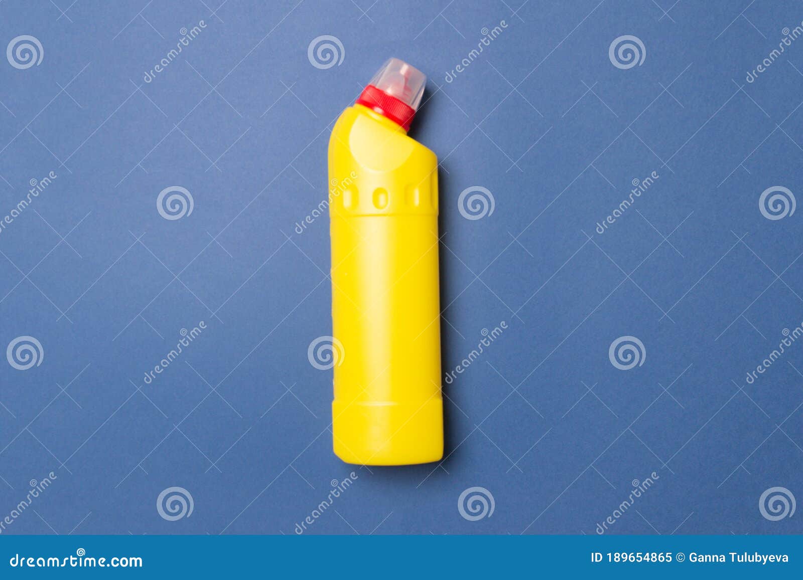 Yellow Bottle with Cleaning Agent on Blue Colored Paper Background ...