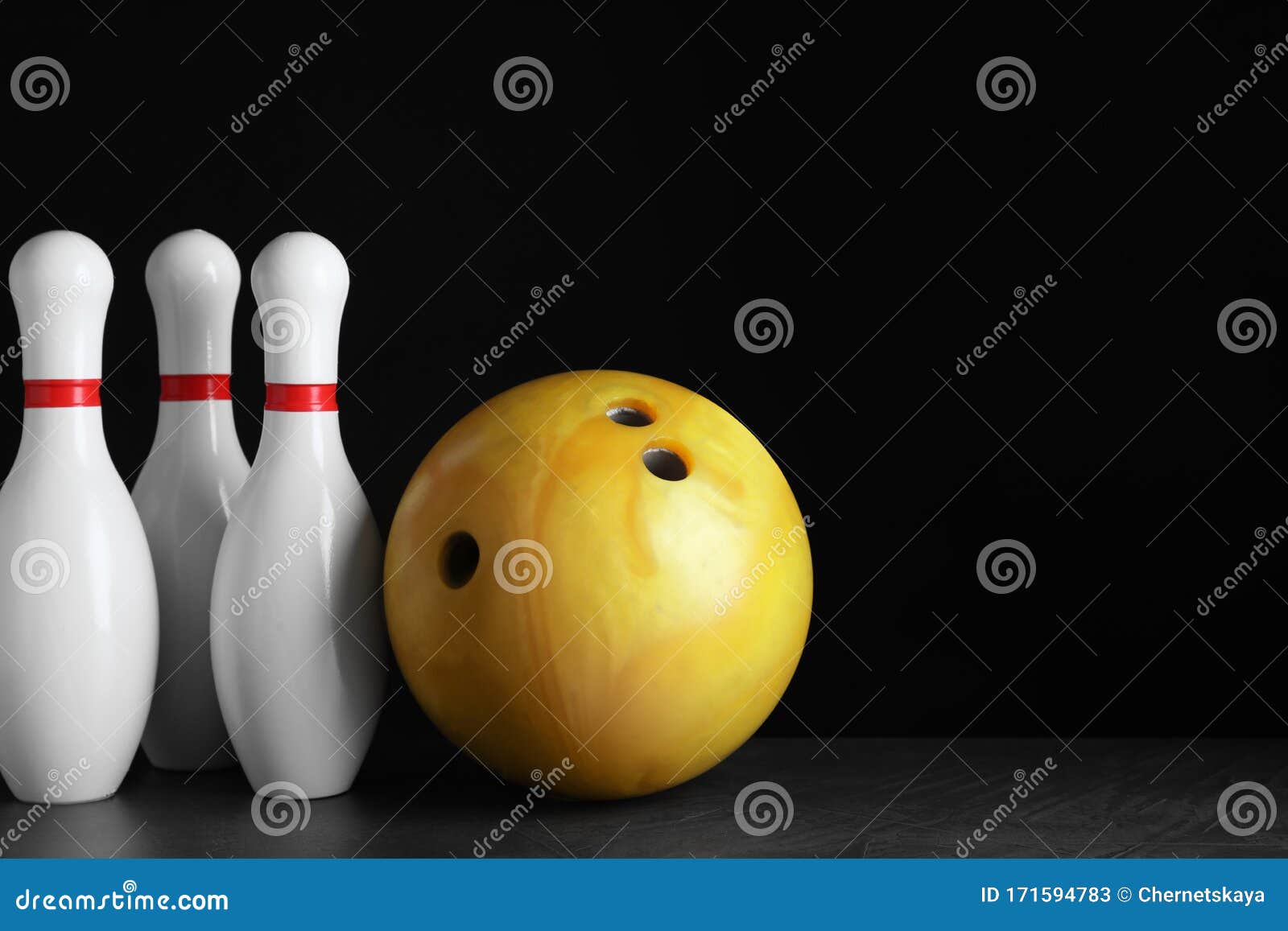 Yellow Bowling Ball and Pins on Black Stone Table Stock Image - Image ...