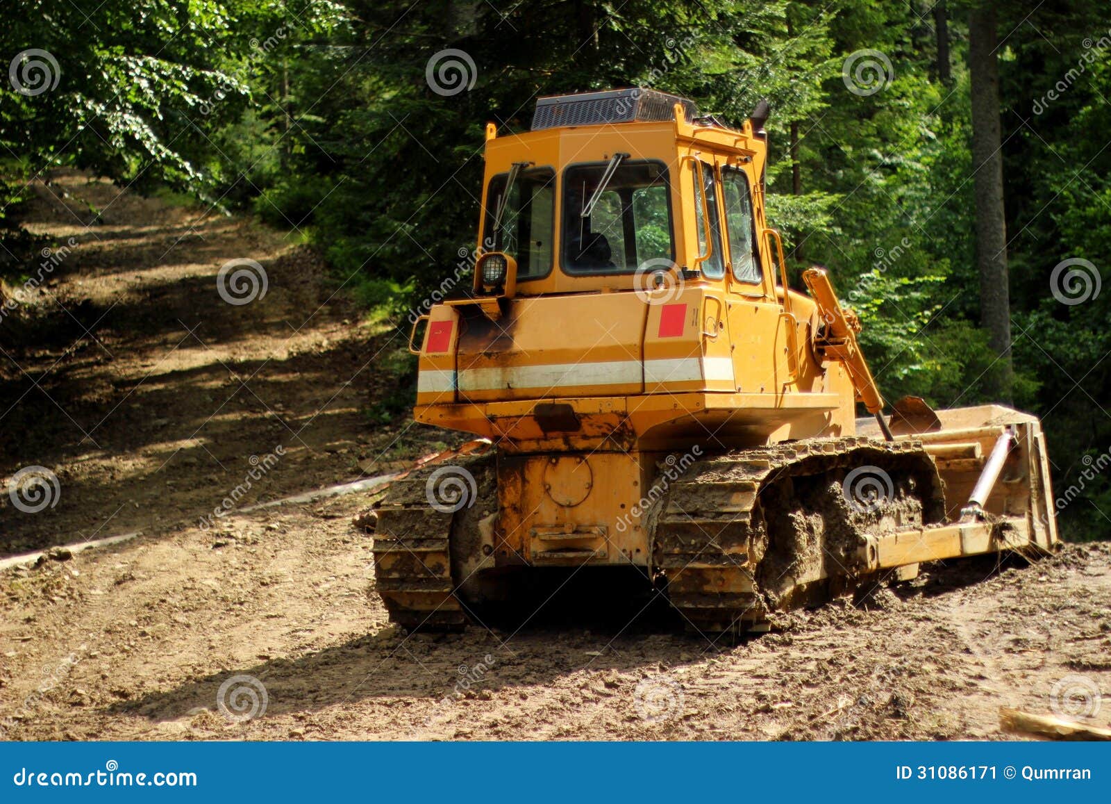 Yellow bulldozer in forest stock image. Image of track - 31086171
