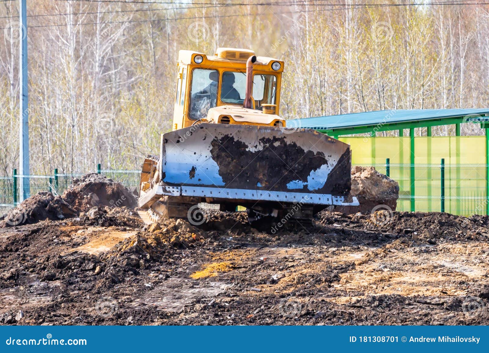 Yellow Bulldozer Leveling the Ground at a Construction Site Stock Image ...