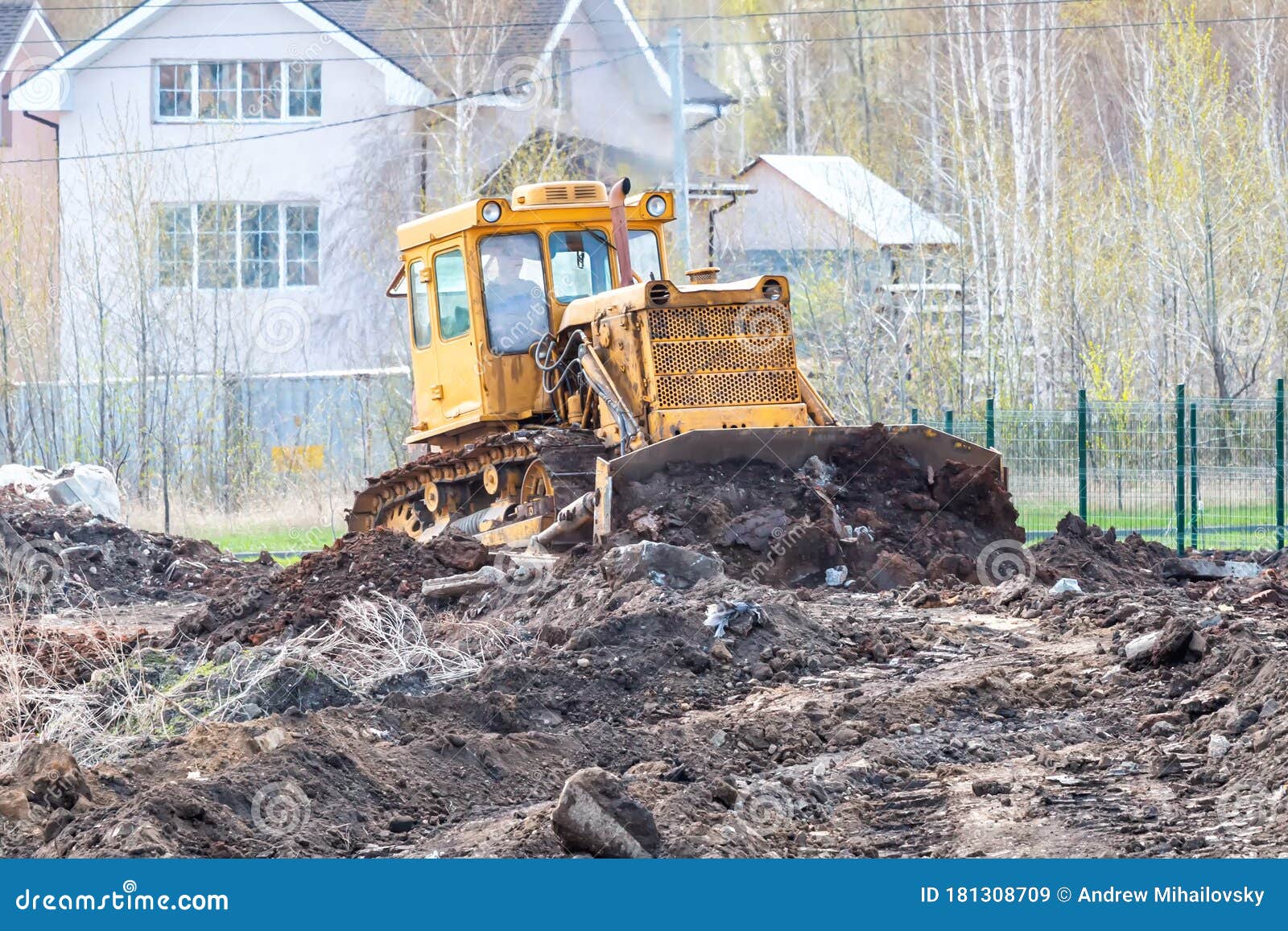 Yellow Bulldozer Leveling the Ground at a Construction Site Stock Image ...