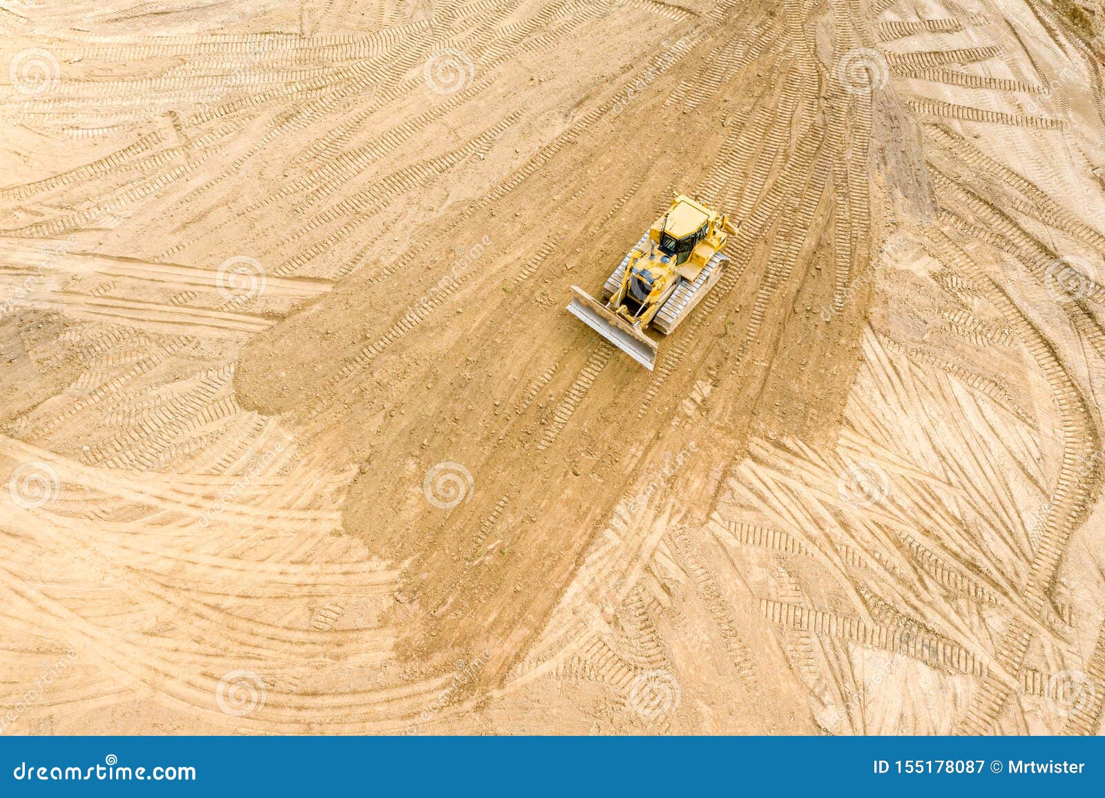 Yellow Bulldozer on Tracks Leveling the Ground before Highway ...