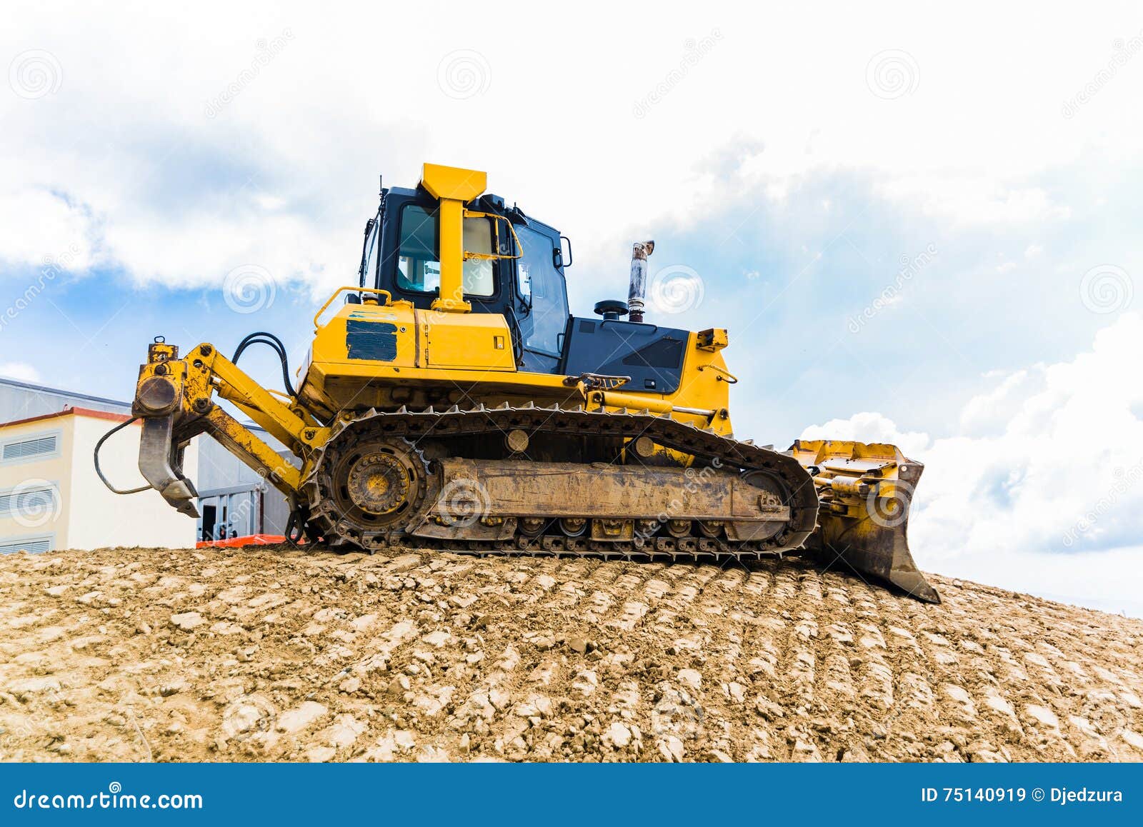 Yellow bulldozer on tracks stock image. Image of construction - 75140919