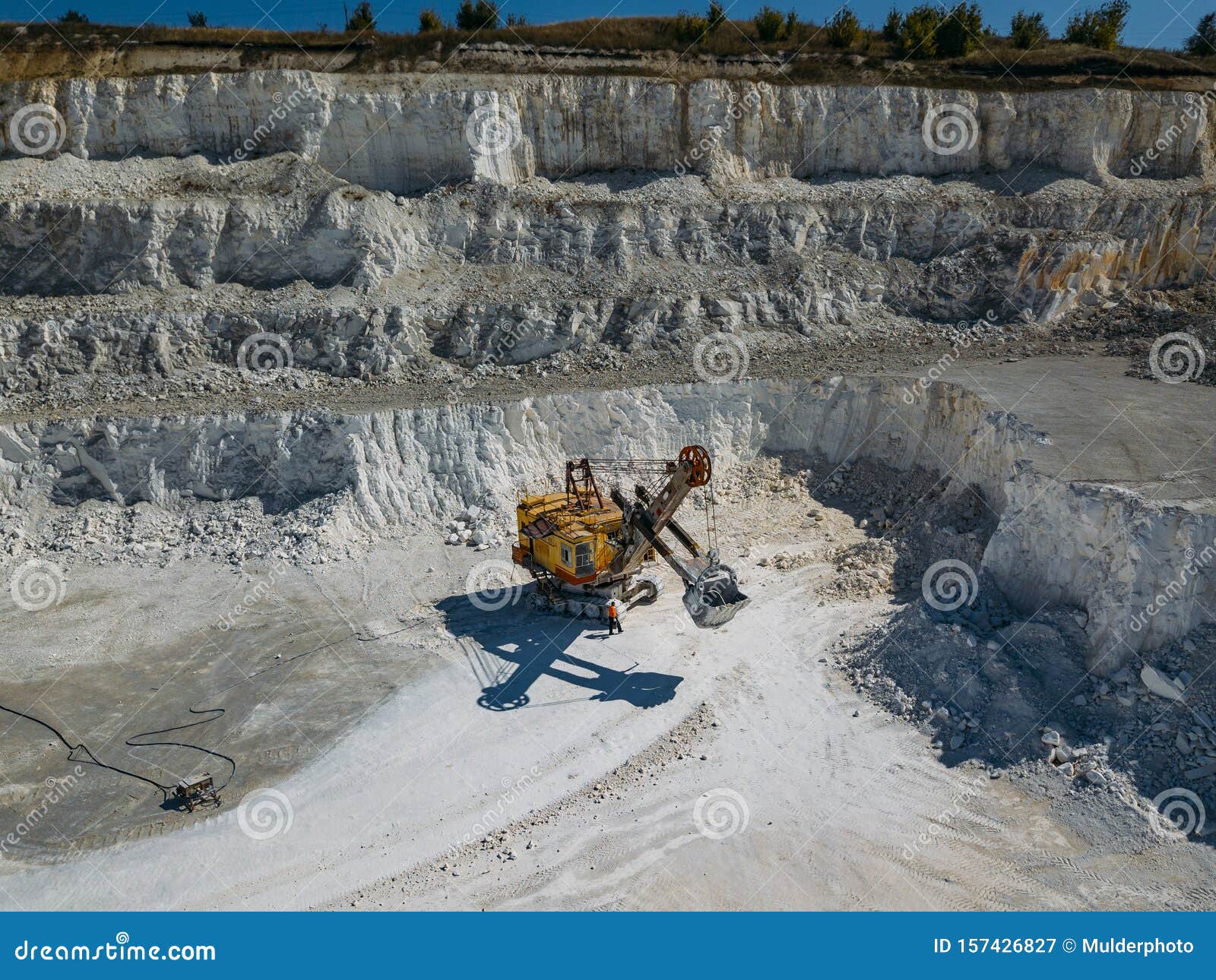 Yellow Cable-operated Excavator Working in Chalk Quarry Stock Image ...