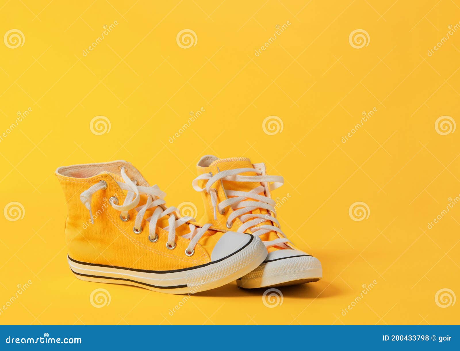 Yellow Canvas Shoes on Yellow Background Stock Photo - Image of ...