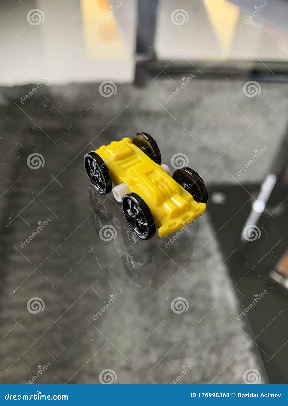 A Yellow Car with Black Wheels is on the Table.Kids Toy Stock Photo ...