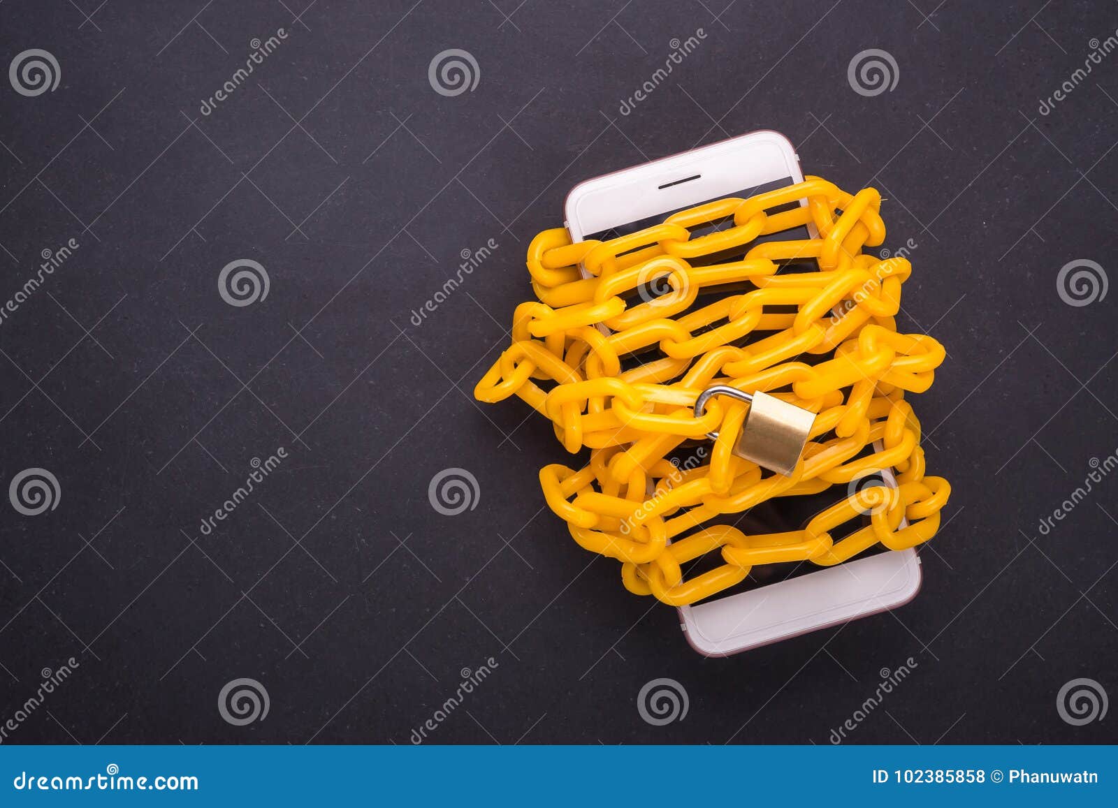 Yellow Chain Locked Around the Smartphone on Black Stone Board. Stock ...