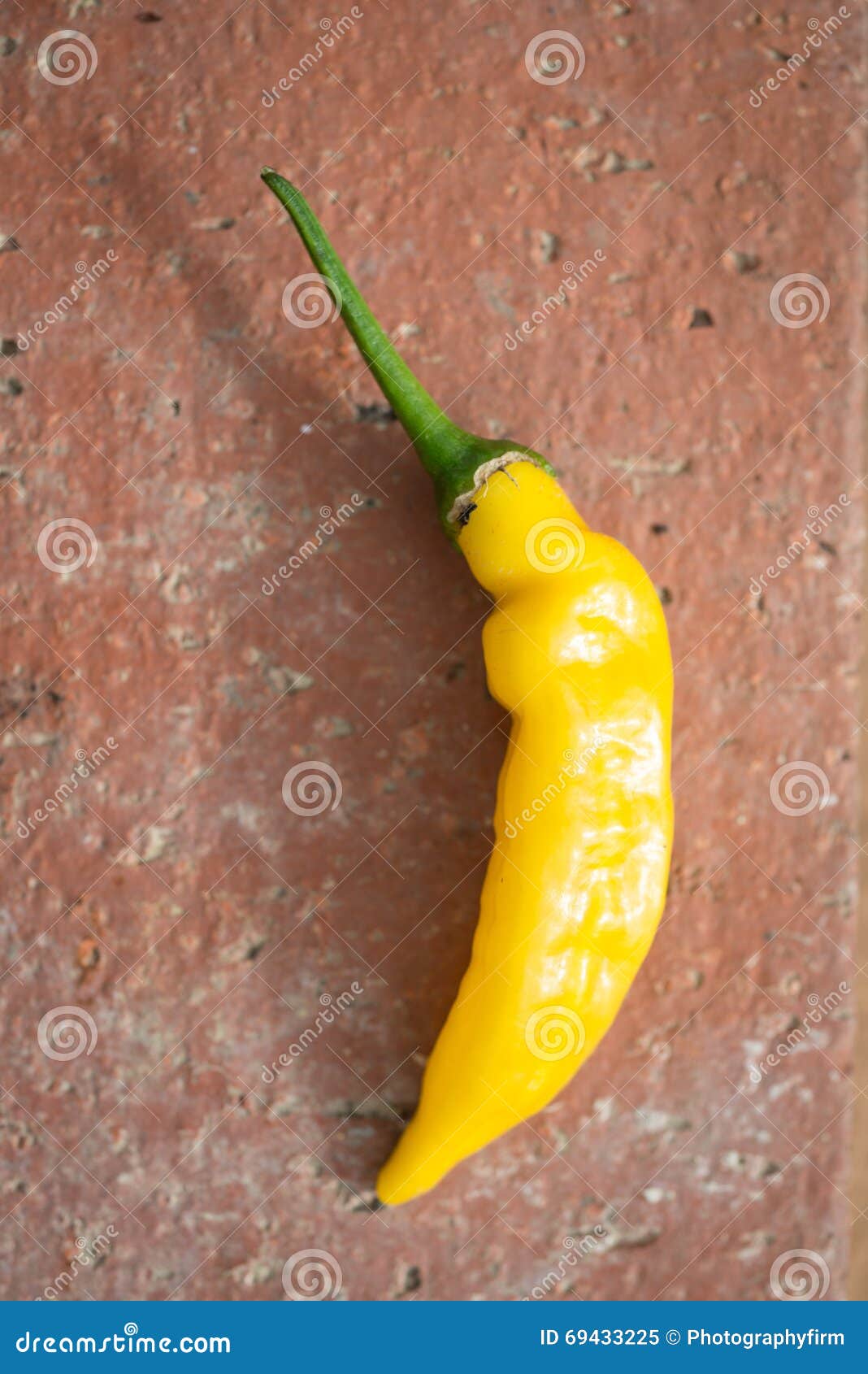 Yellow Chilli Pepper Against Red Brick Background Stock Image - Image ...