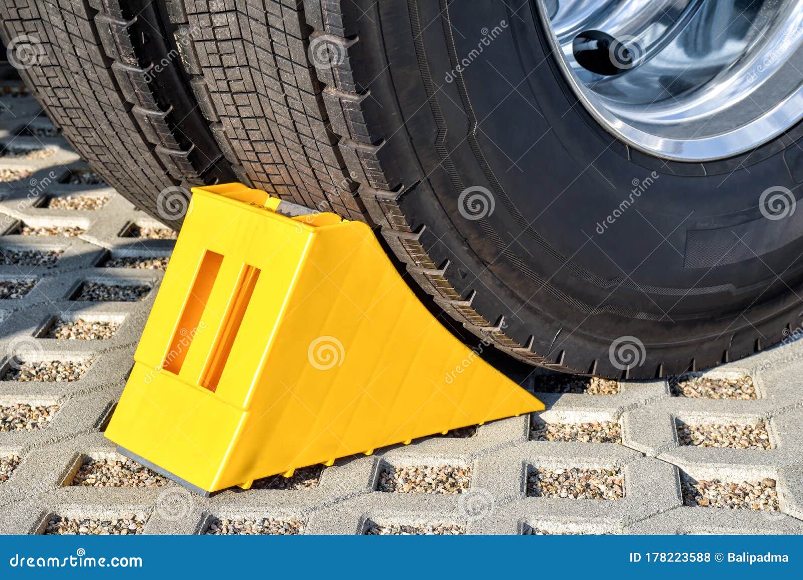 Yellow Chock at the Wheel of a Parked Truck Stock Photo - Image of ...