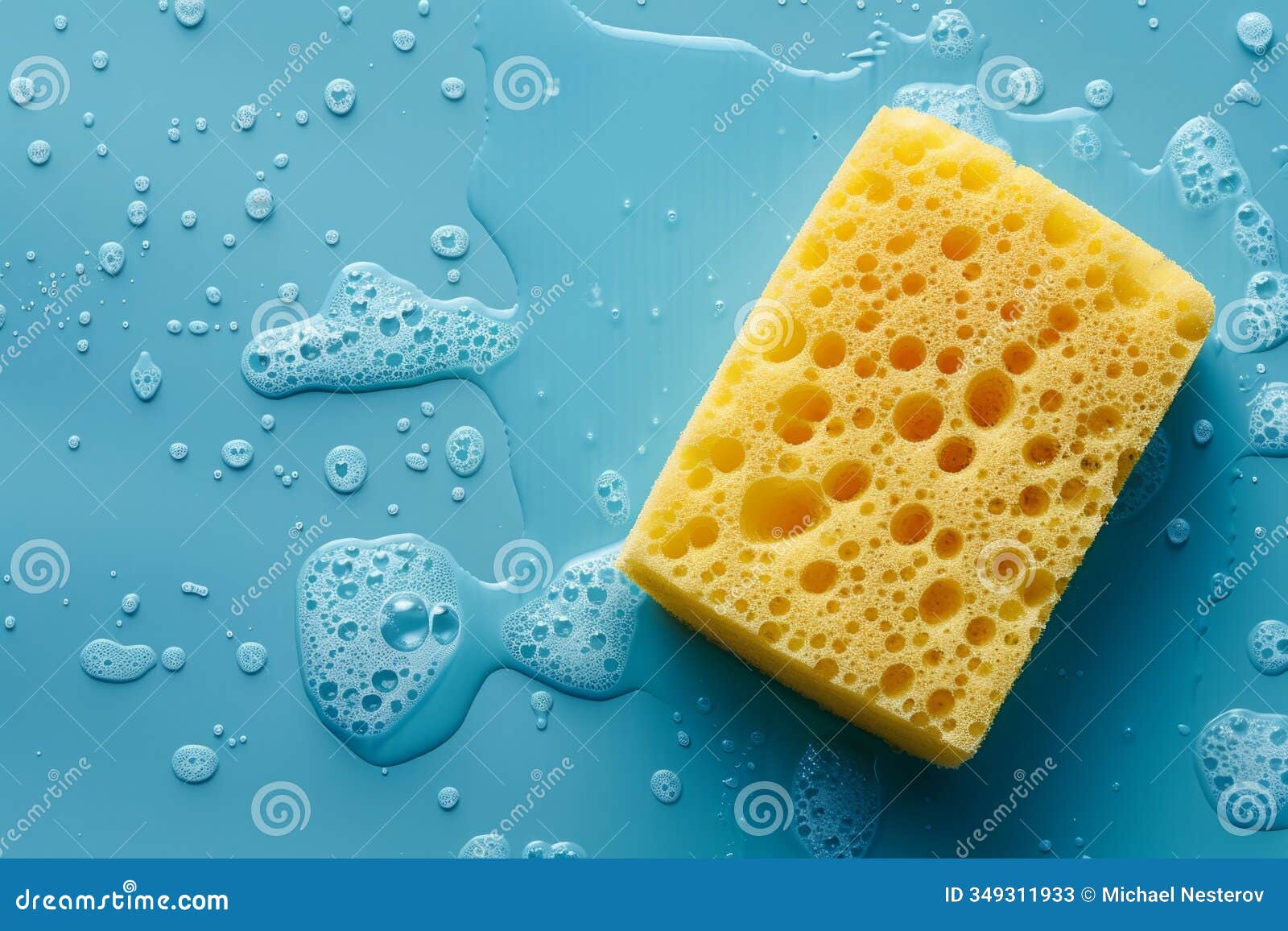Yellow Cleaning Sponge Covered in Soap Suds on Blue Background Stock ...