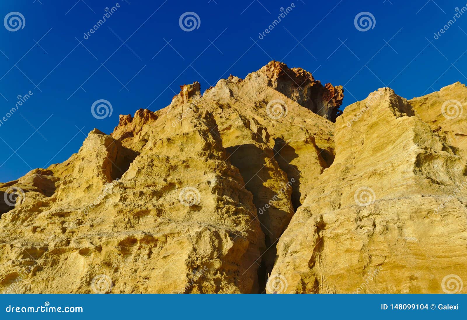 Yellow Cliffs with Blue Sky in Background Stock Photo - Image of ...