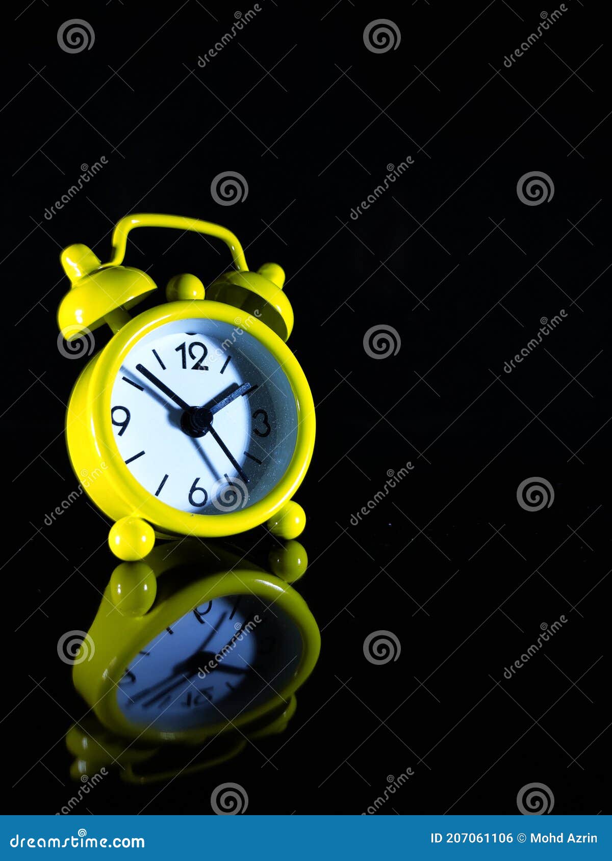A Yellow Clock with Reflection on a Black Background. Stock ...