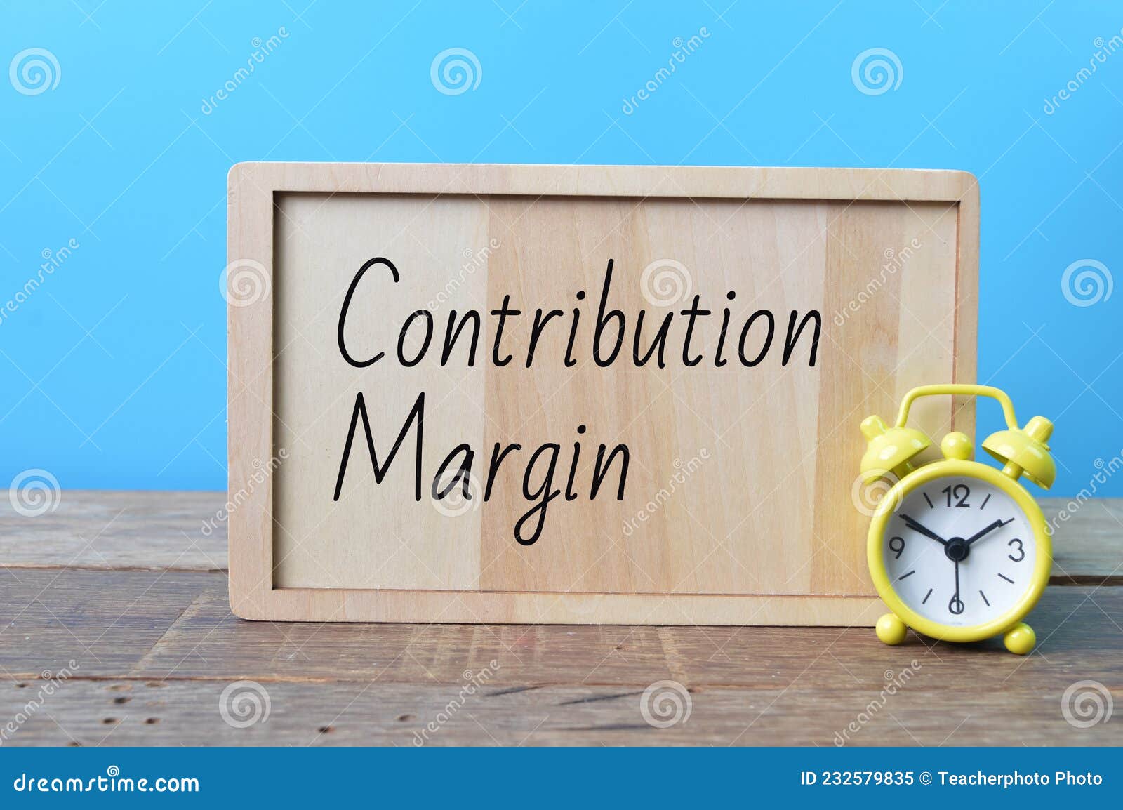 Yellow Clock and Wooden Board Written with Text CONTRIBUTION MARGIN ...