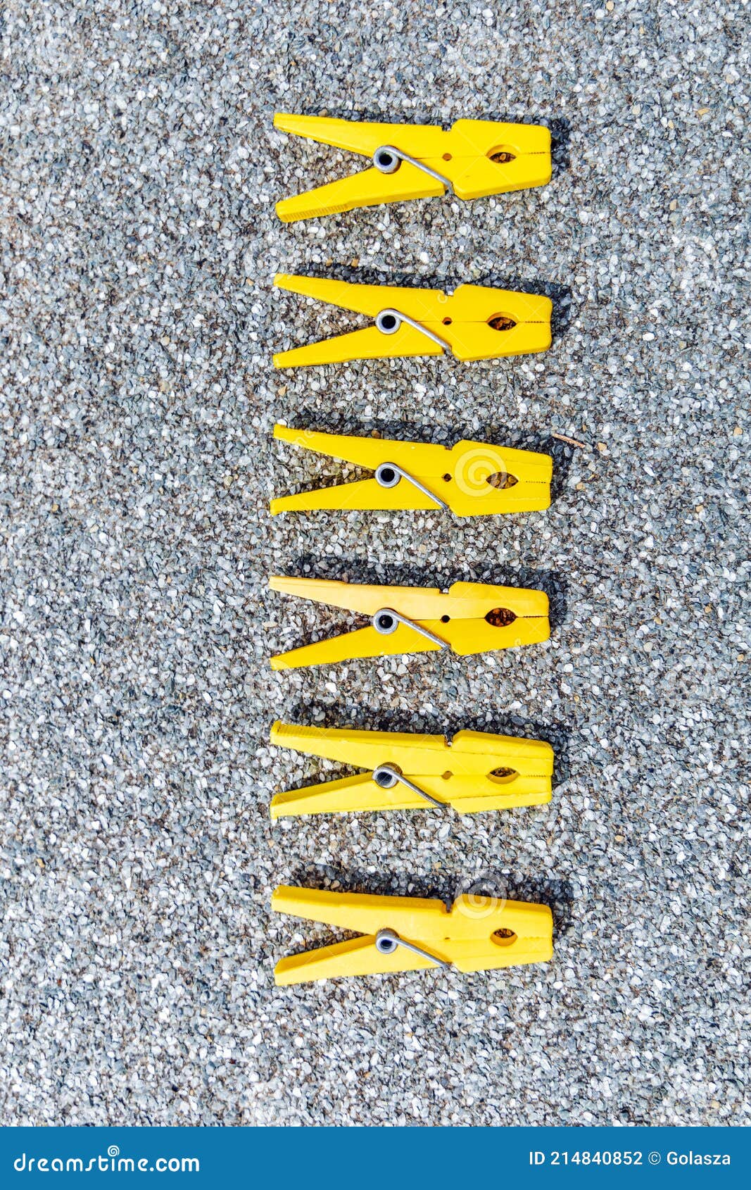 Yellow Clothes Clips in a Raw on Grey Background Stock Photo - Image of ...