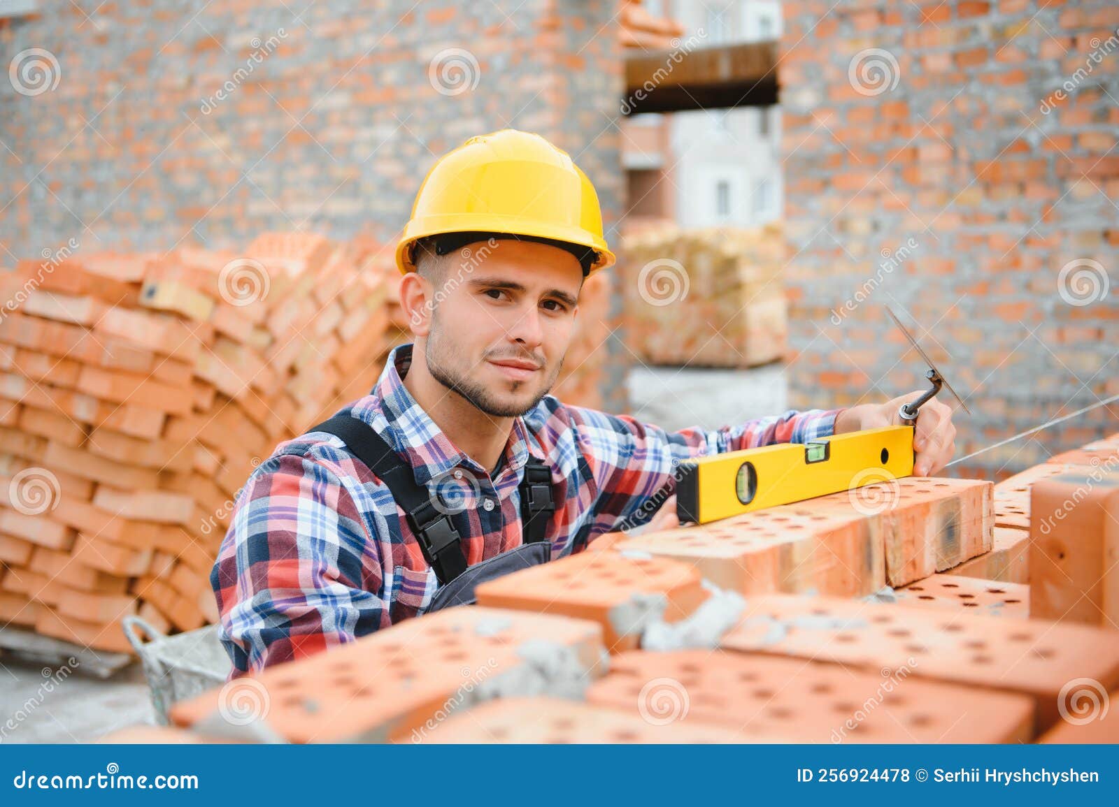 Yellow Colored Hard Hat. Young Man Working in Uniform at Construction ...