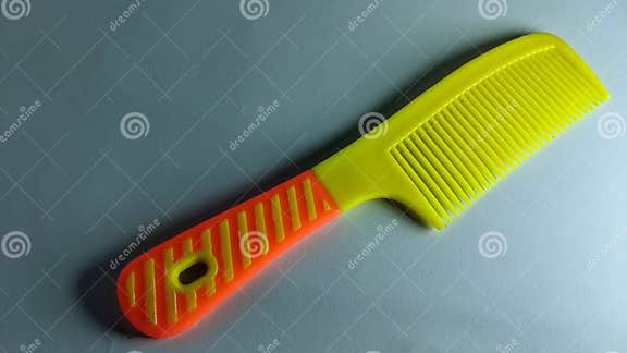 A Yellow Comb with an Orange Handle. the Comb Has a Wide, Rectangular ...
