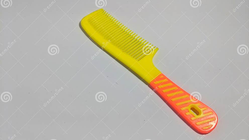 A Yellow Comb with an Orange Handle. the Comb Has a Wide, Rectangular ...