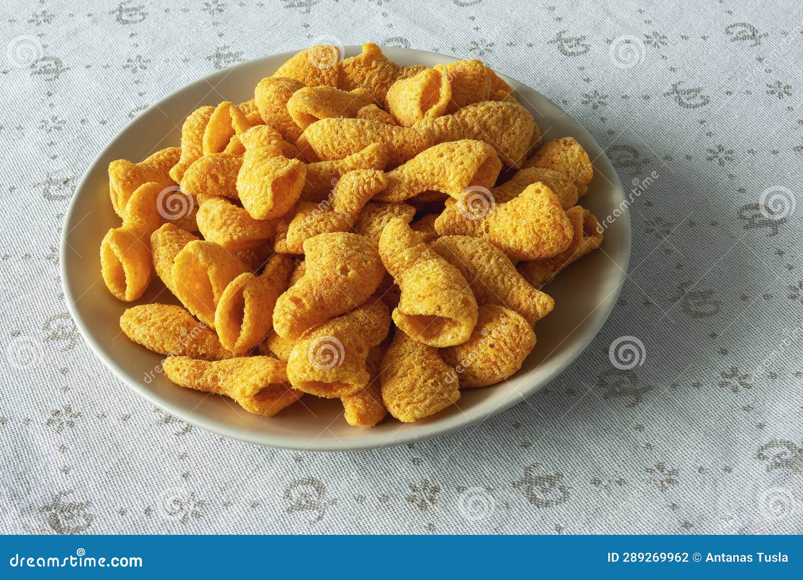 Yellow Cone-shaped Snack Crackers on a Plate Stock Photo - Image of ...