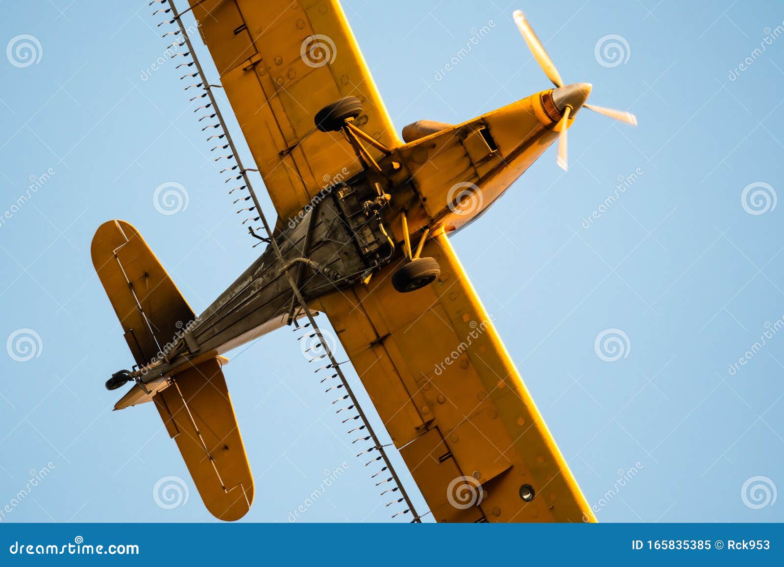 Yellow Crop Dusting Plane Flying in a Blue Sky Stock Image - Image of ...