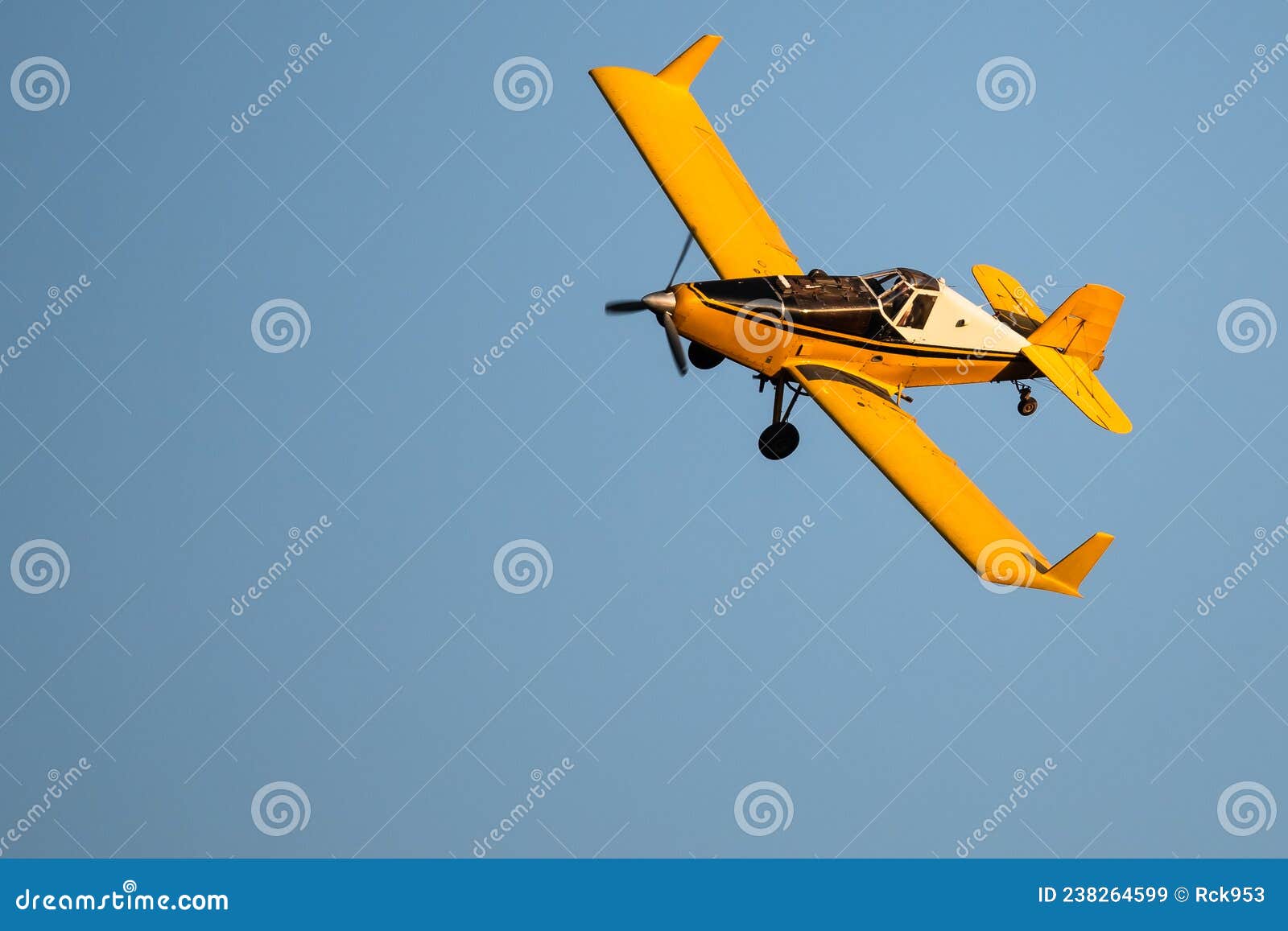 Yellow Crop Dusting Plane Flying in a Blue Sky Stock Image - Image of ...
