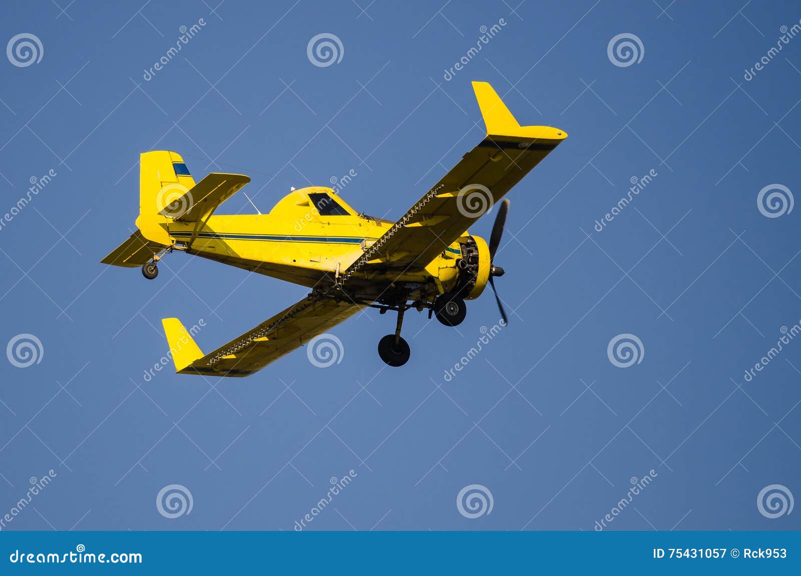 Yellow Crop Dusting Plane Flying in a Blue Sky Stock Image - Image of ...