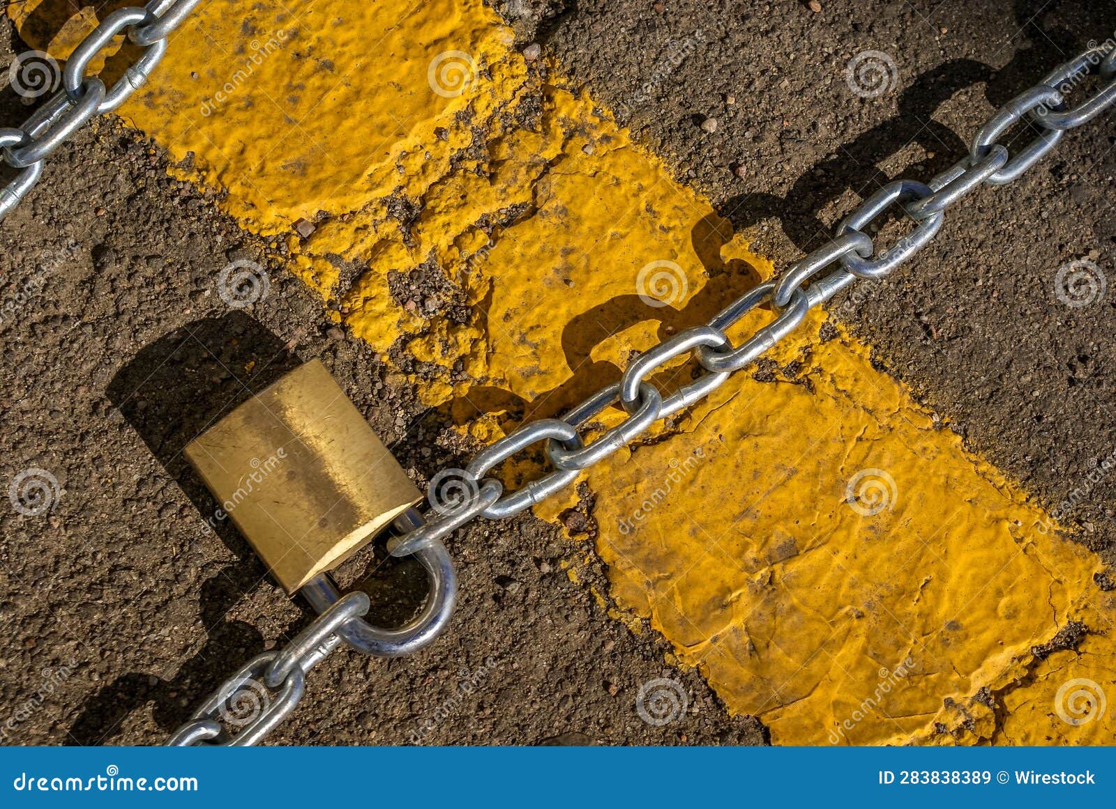 Yellow Curb with Two Heavy Chains Securely Held Together with a Padlock ...
