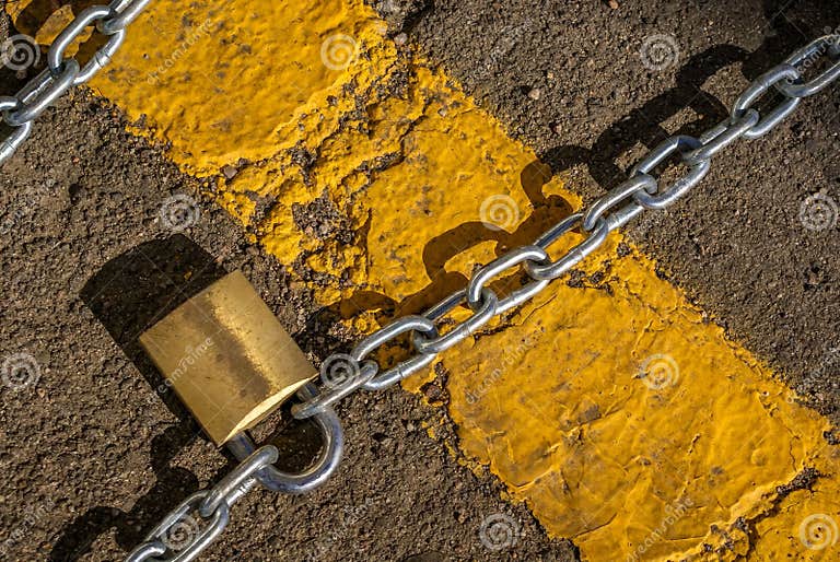 Yellow Curb with Two Heavy Chains Securely Held Together with a Padlock ...